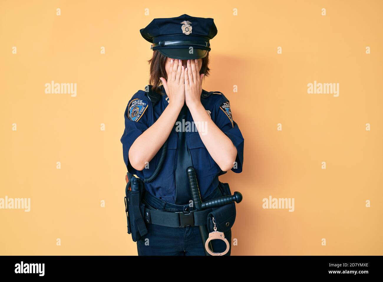 Young beautiful woman wearing police uniform with sad expression ...