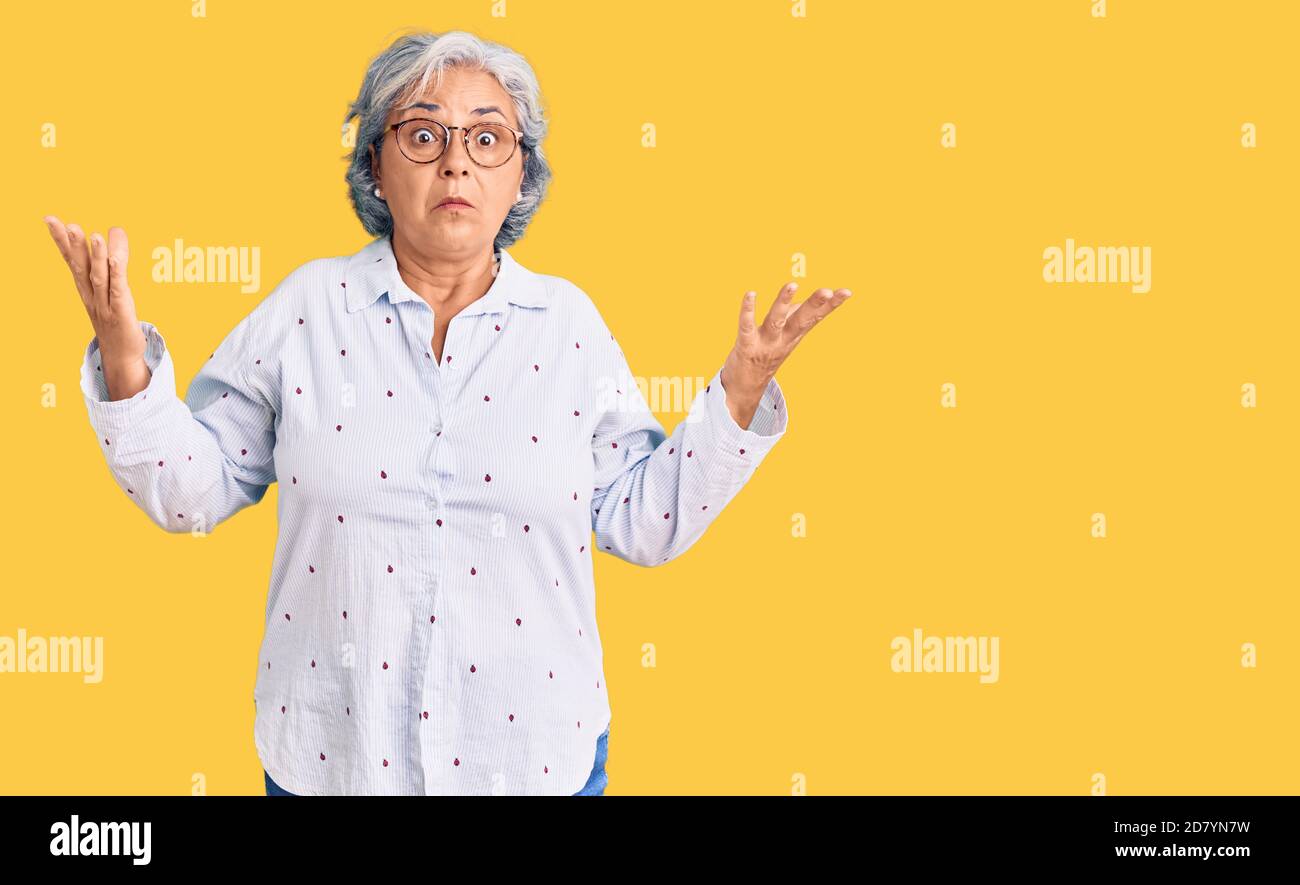 Senior woman with gray hair wearing casual business clothes and glasses ...