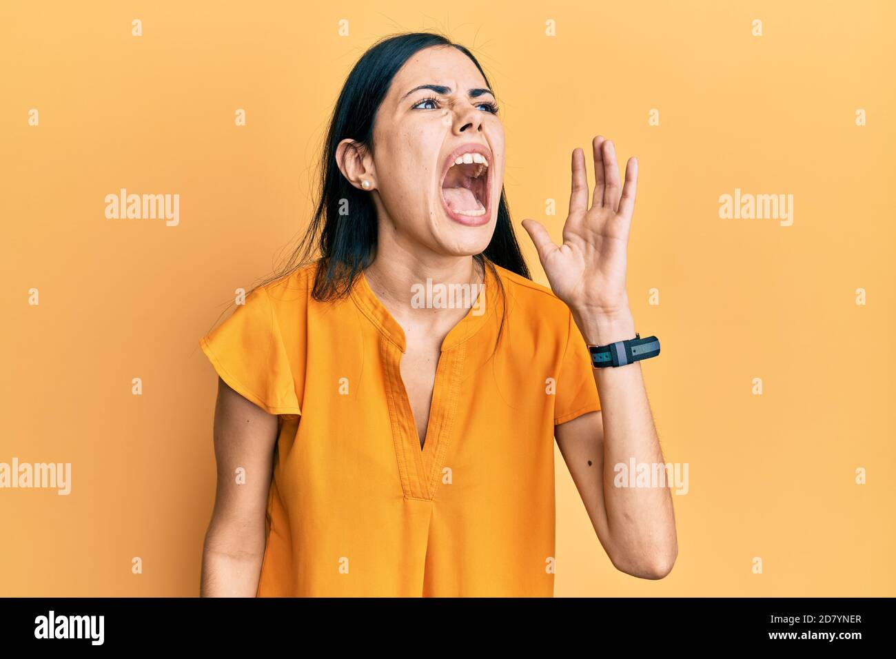 Beautiful young woman wearing casual clothes shouting and screaming ...