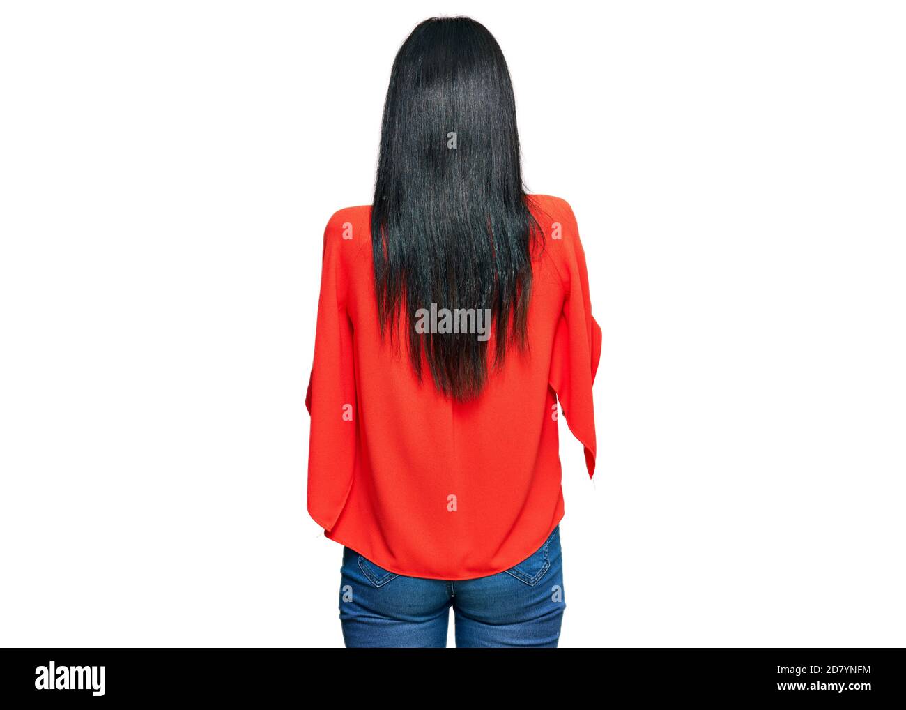 Beautiful young woman wearing casual clothes standing backwards looking ...