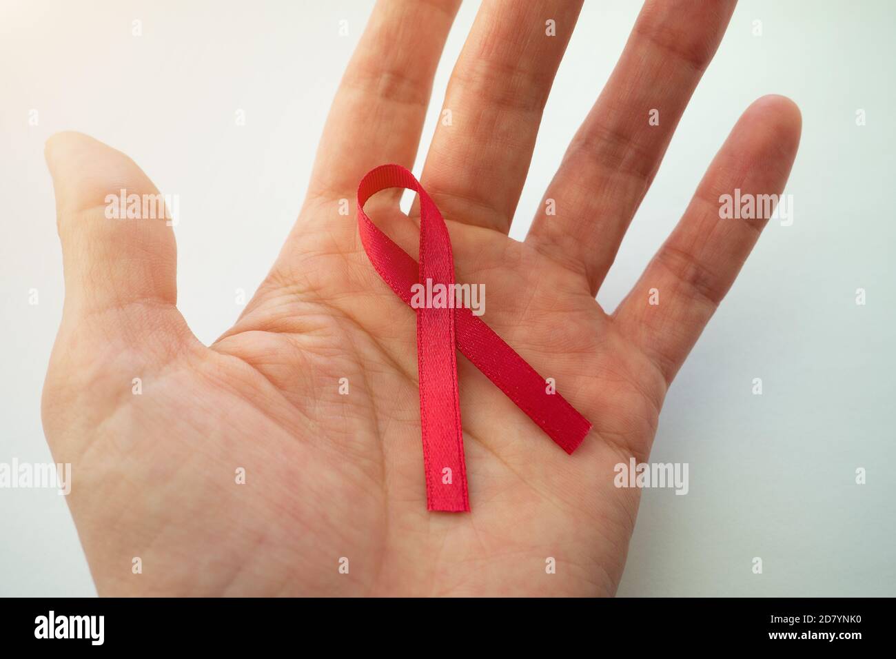 Female hands holding red ribbon HIV, AIDS awareness ribbon, healthcare ...