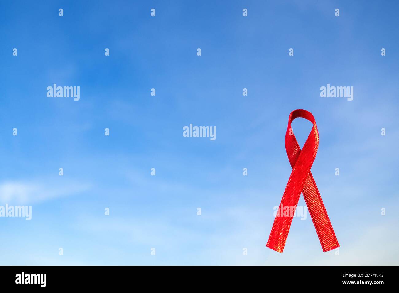 Aids Awareness Sign red ribbon with copy space for add text on blue sky ...