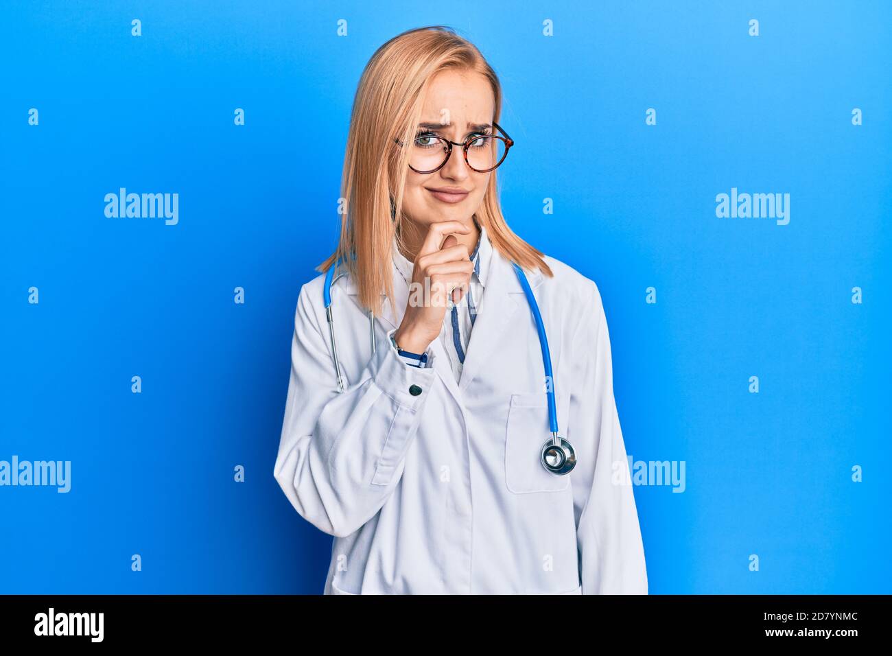 Beautiful caucasian woman wearing doctor uniform thinking concentrated ...
