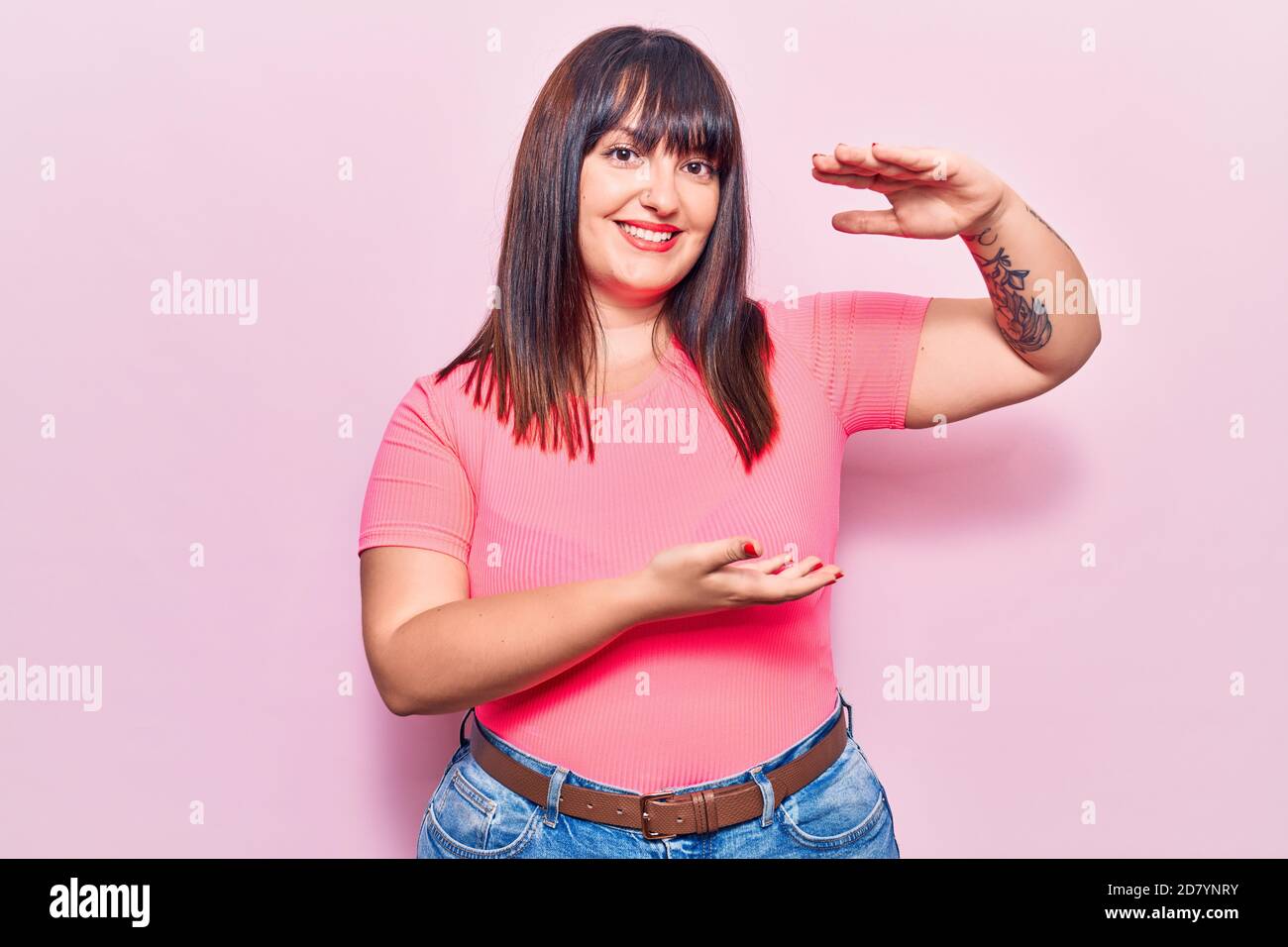 Young plus size woman wearing casual clothes gesturing with hands ...