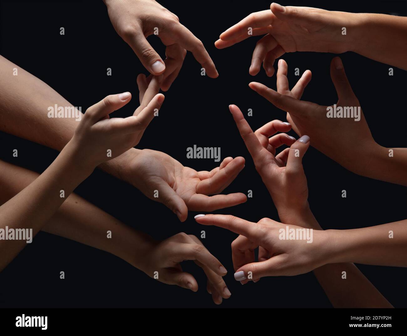 Friendship. Hands of people's crows in touch isolated on black studio ...