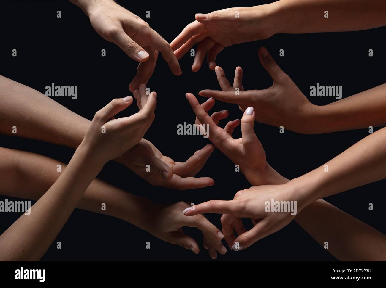 Friendship. Hands of people's crows in touch isolated on black studio ...