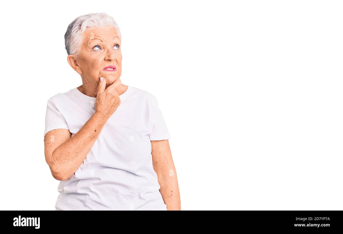 Senior beautiful woman with blue eyes and grey hair wearing casual ...