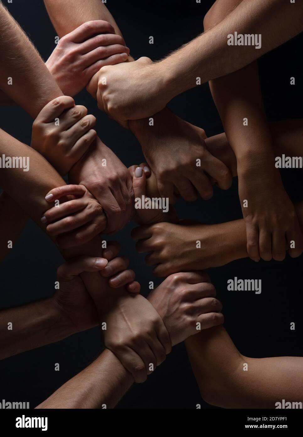 Forces. Hands of people's crows in touch isolated on black studio ...