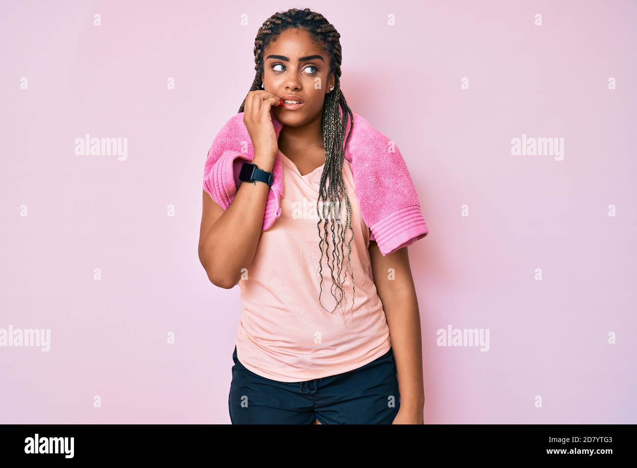 Young african american woman with braids wearing sportswear and towel ...