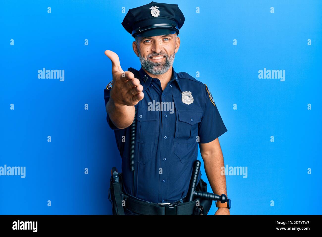 Middle age handsome man wearing police uniform smiling friendly ...