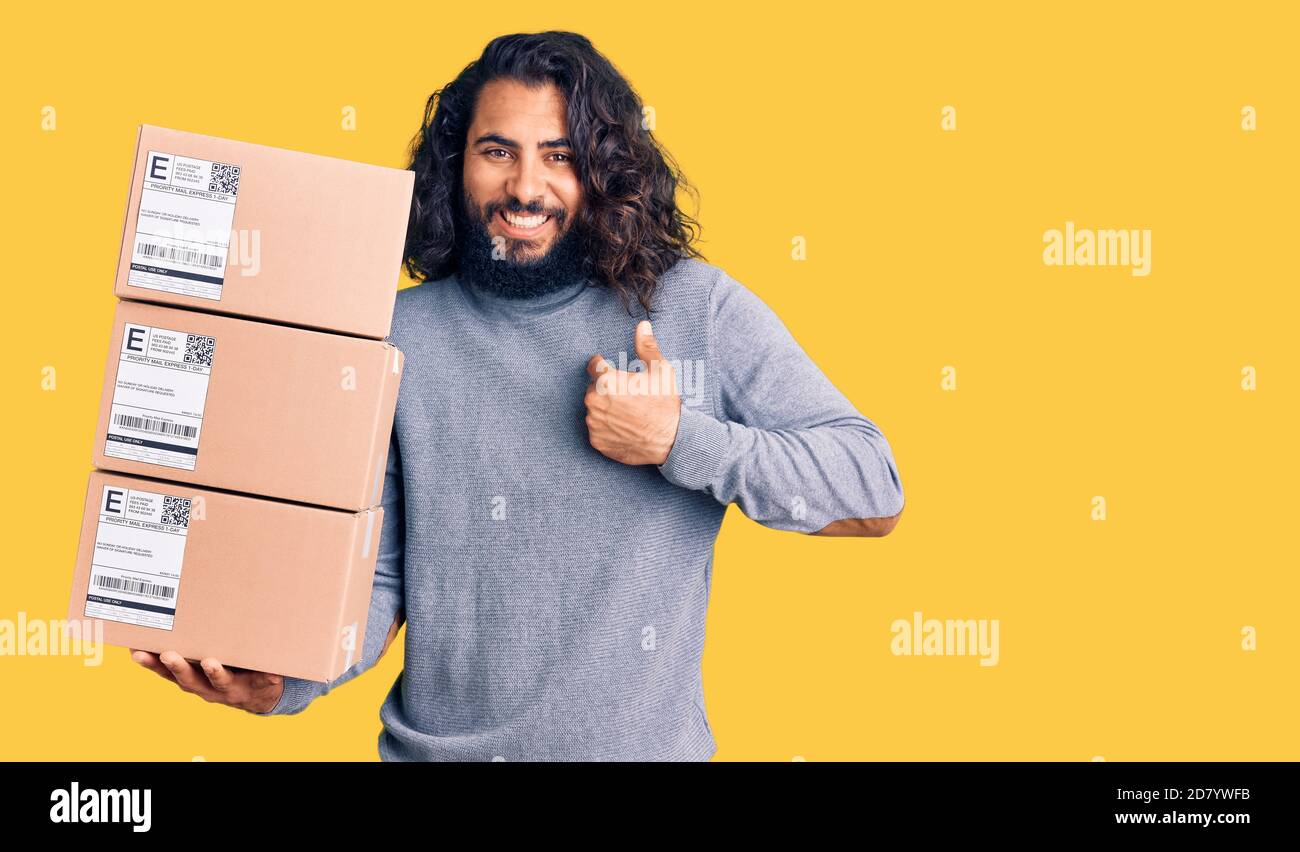 Young arab man holding delivery package pointing finger to one self ...