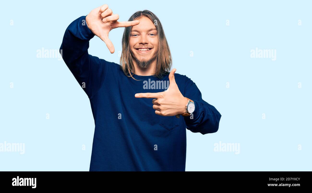 Handsome caucasian man with long hair wearing casual winter sweater ...