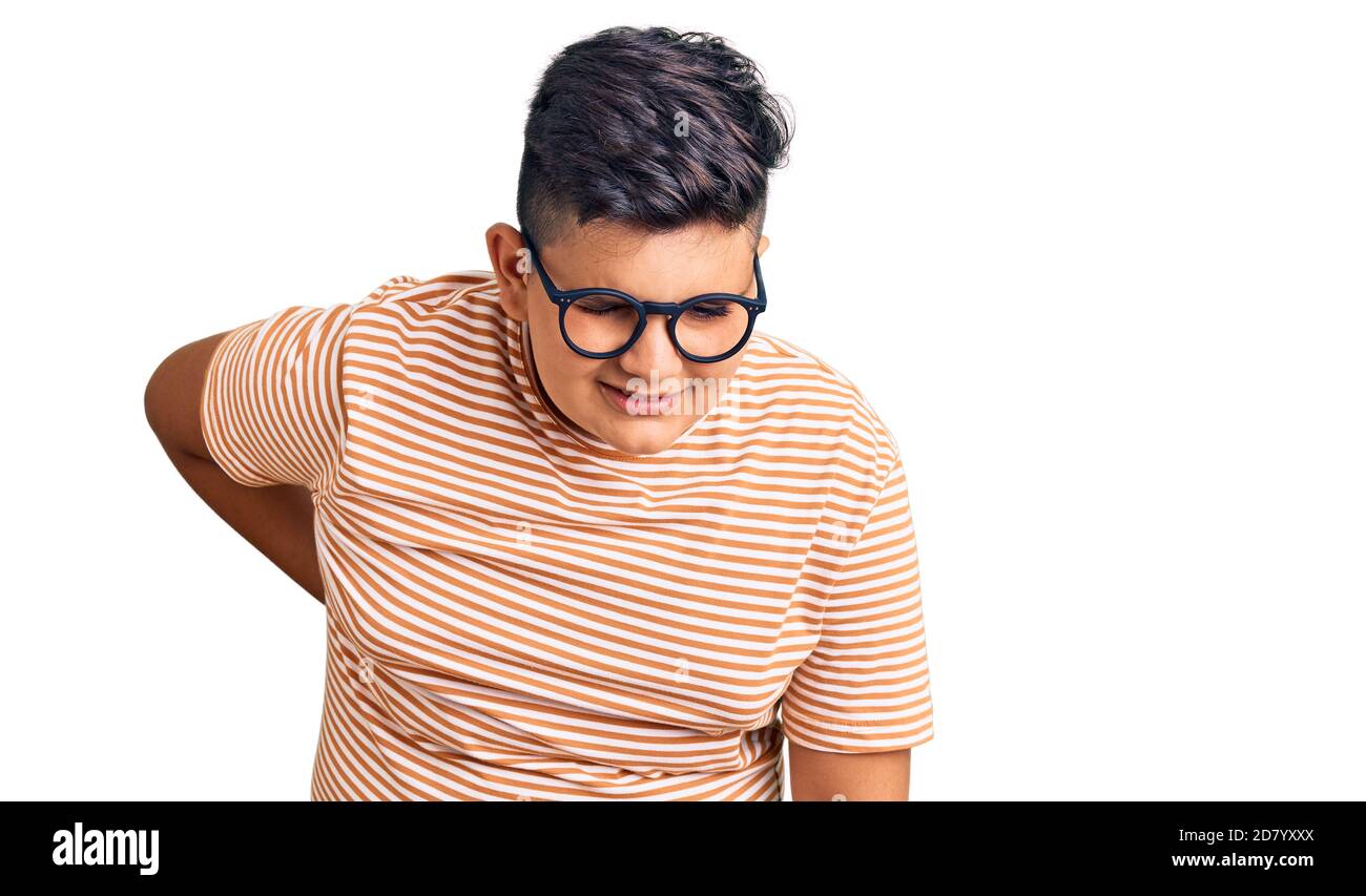 Little boy kid wearing casual clothes and glasses suffering of backache ...