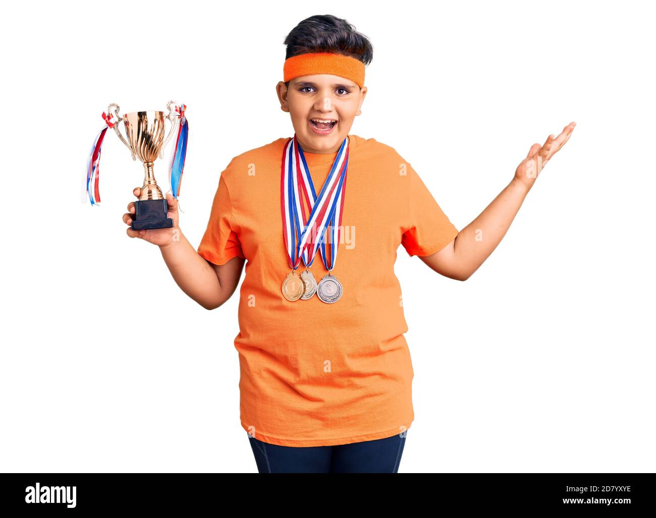 Little boy kid holding champion trophy and wearing medals celebrating ...