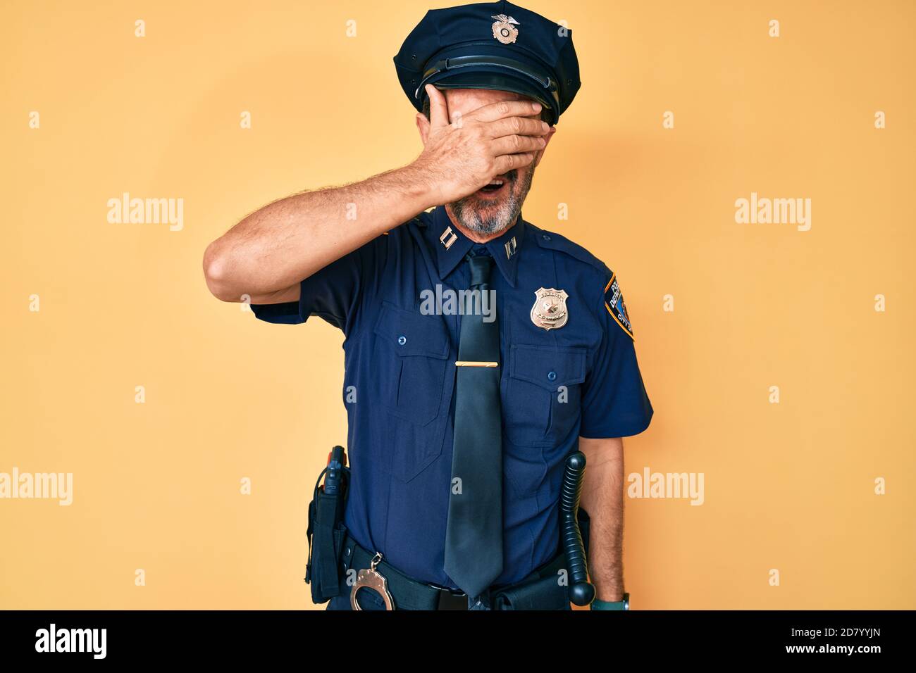 Middle age hispanic man wearing police uniform smiling and laughing ...