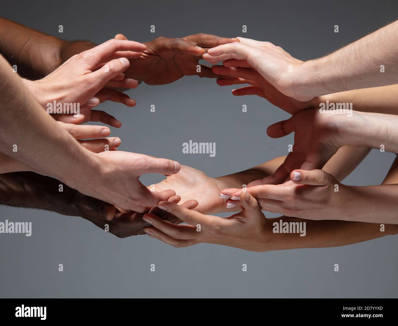 Save. Hands of people's crows in touch isolated on grey studio ...
