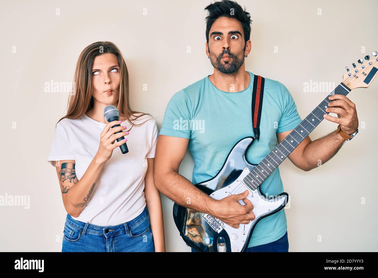 Beautiful young couple of boyfriend and girlfriend singing song using ...