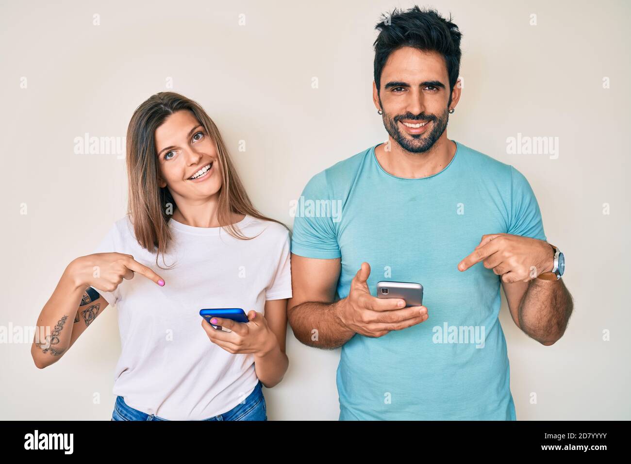 Beautiful young couple of boyfriend and girlfriend using smartphone ...