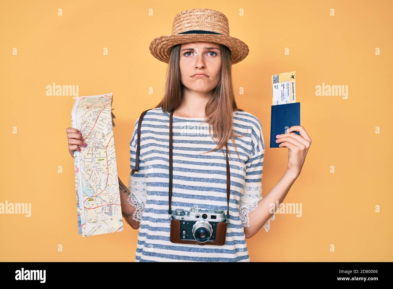 Beautiful caucasian tourist woman holding city map and passport ...