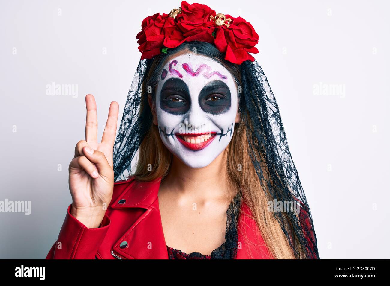 Woman wearing day of the dead costume over white smiling with happy ...
