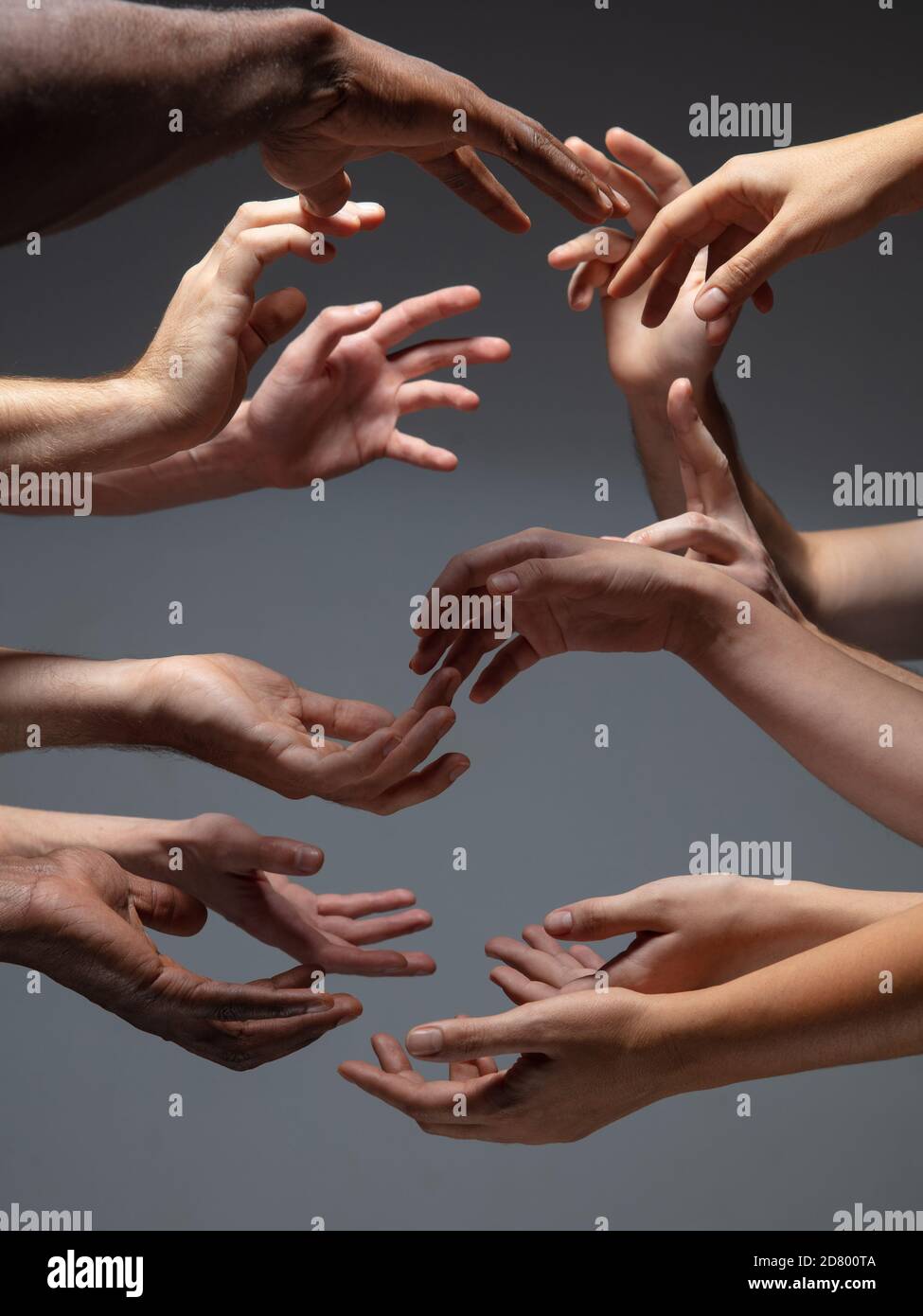 Voices. Hands of people's crows in touch isolated on grey studio ...