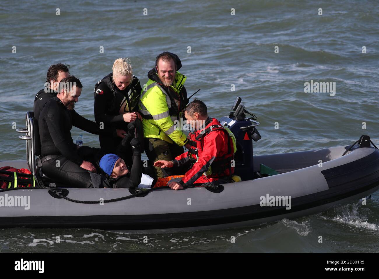 Former paratrooper John Bream (centre, wearing blue hat) is picked up ...