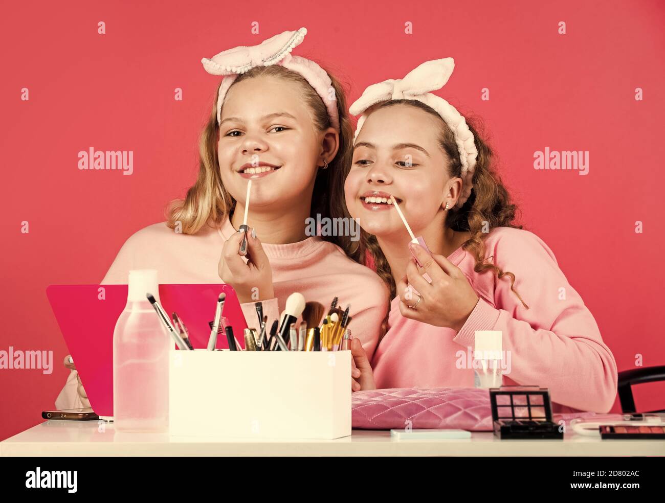 Cosmetics shop. Happy girls doing makeup. Sisters play with cosmetics ...