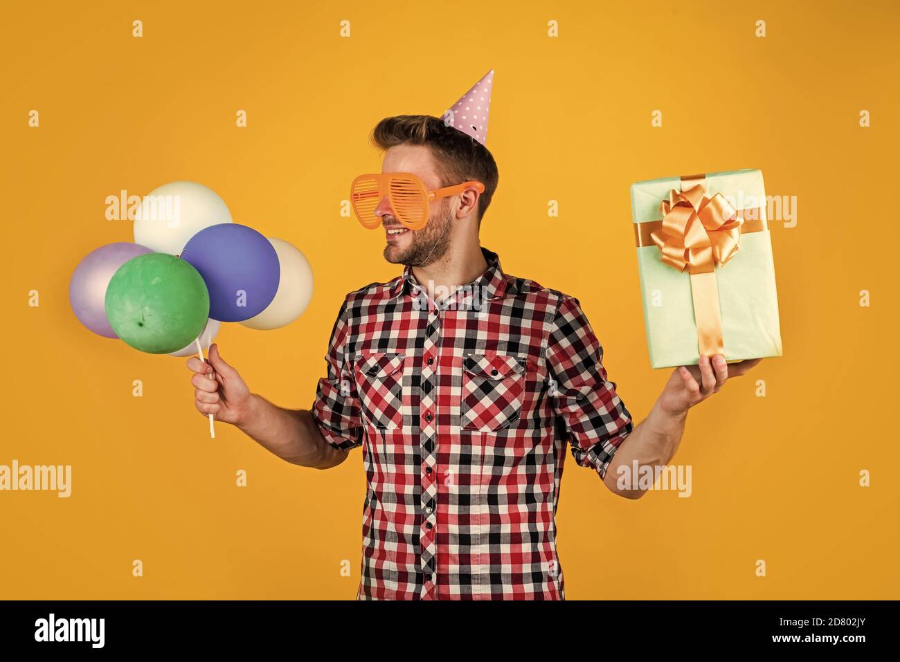 Real shopaholic. guy hold festive balloons. happy holiday celebration ...