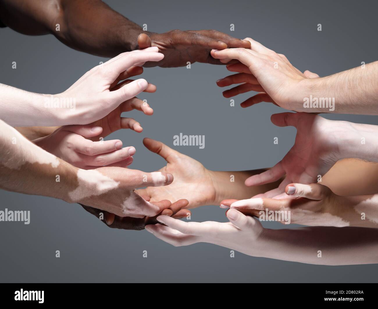 Planet Earth. Hands of different people in touch isolated on grey ...