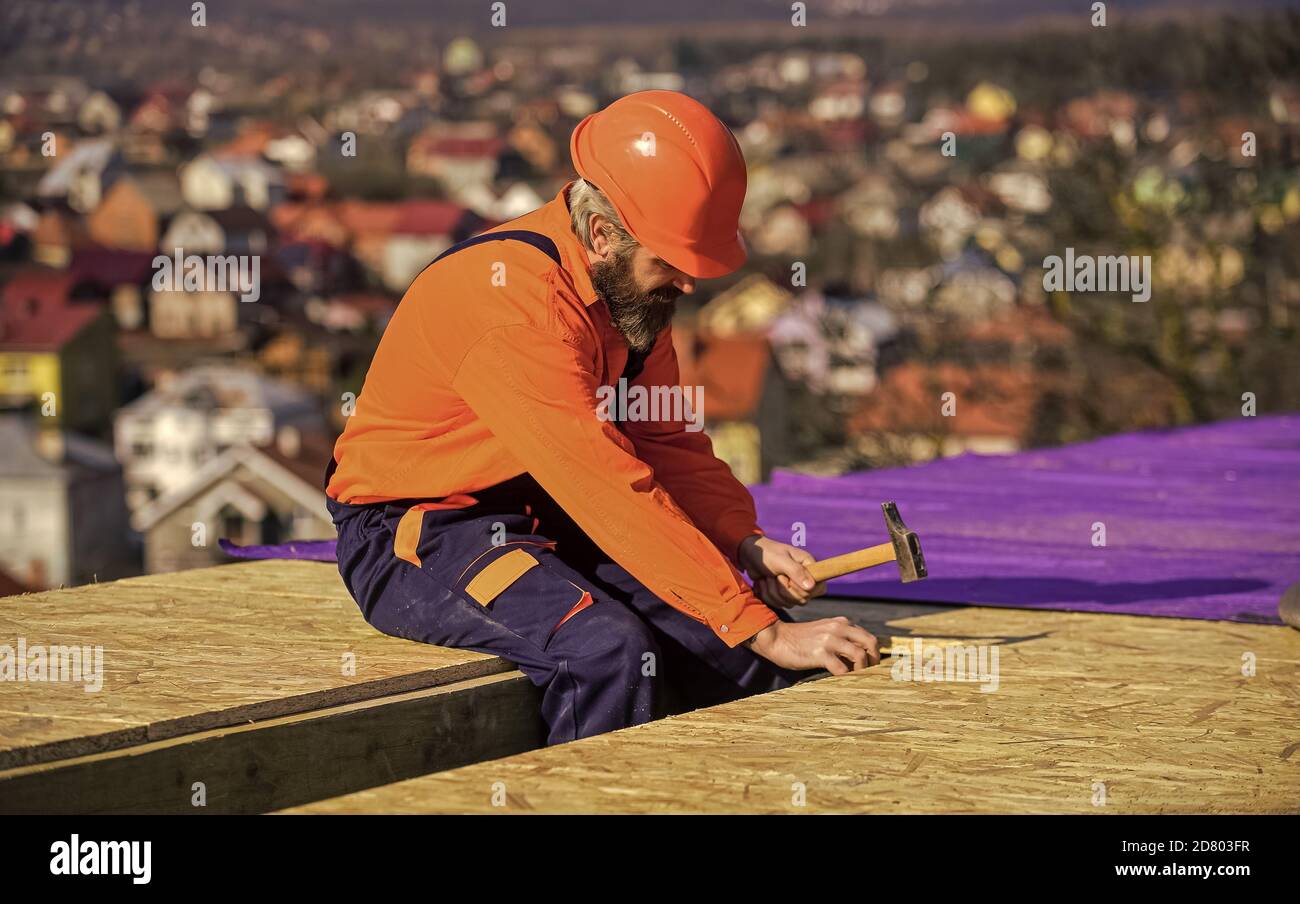 Construction Industry and Waterproofing. roofer working on roof ...
