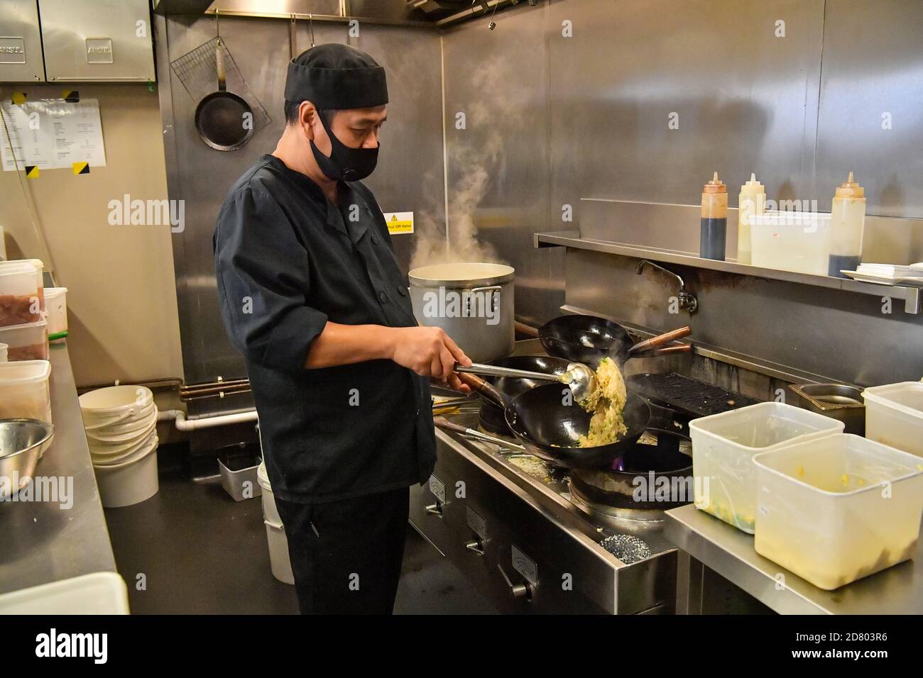 A chef prepares food for free lunch bags at Pho in Bristol, who are ...