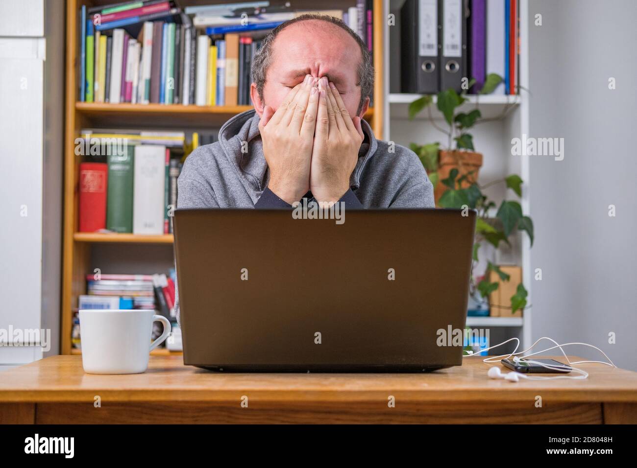 Frustrated man, working online from home office on computer laptop ...