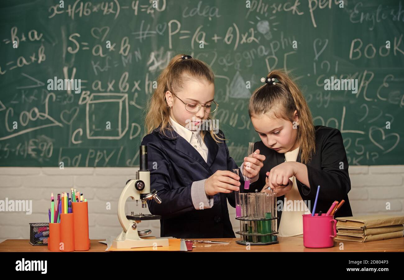 Chemistry research in laboratory. Little girls in school lab. Teamwork ...