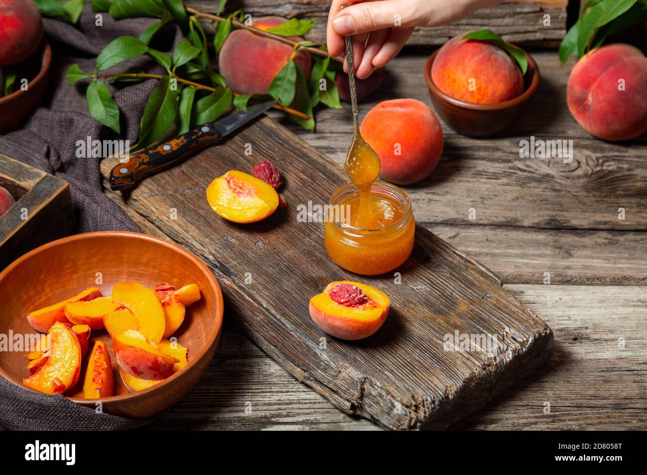 The process of making peach jam, cooking peach dessert on rustic ...