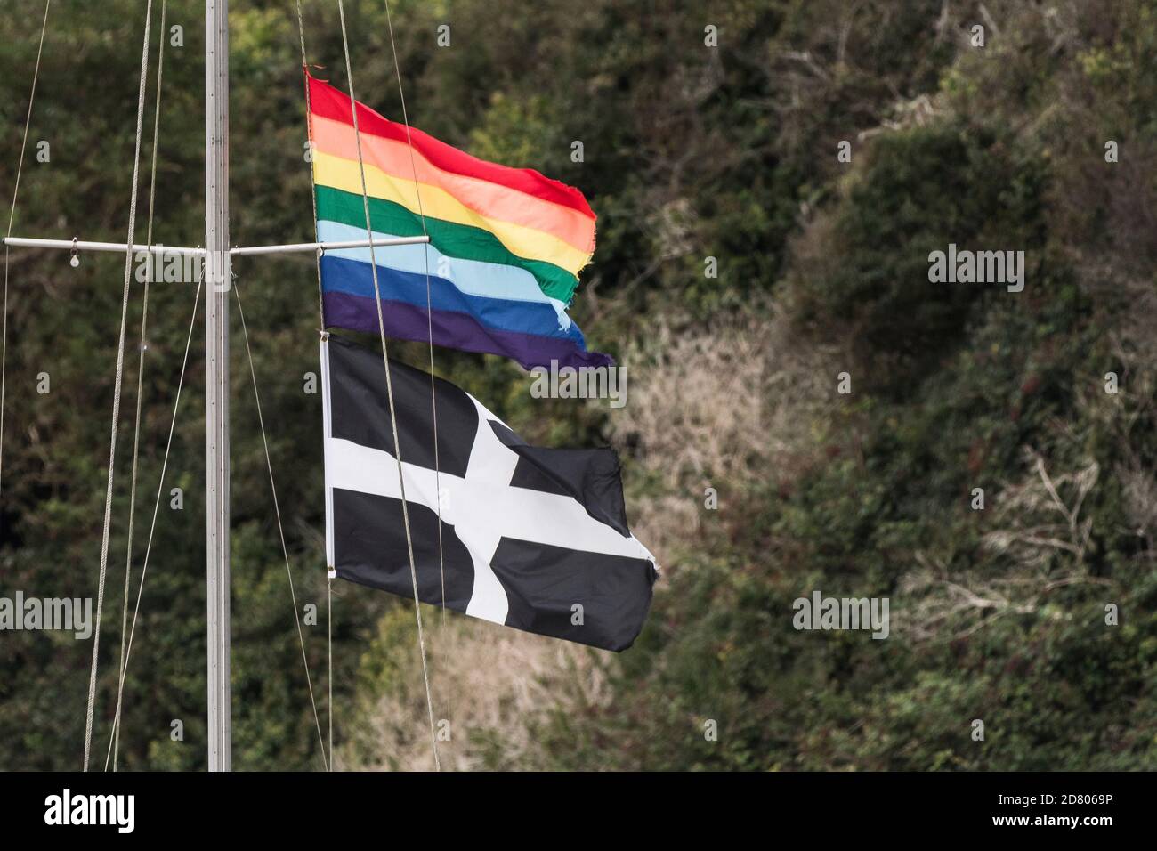 A Rainbow flag and a Cornish St Piran flag flying from the mast of a ...