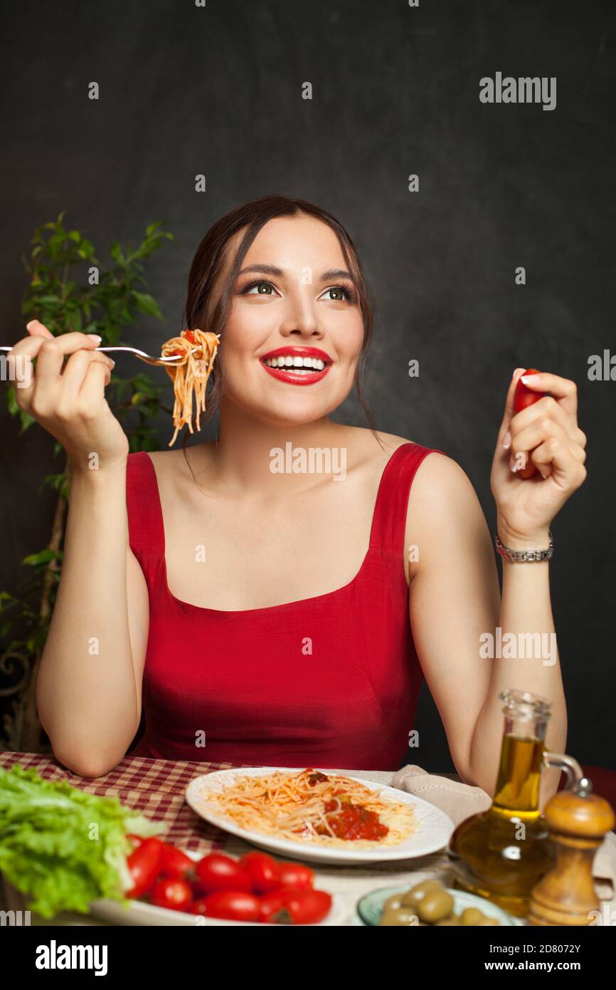Nice woman eating pasta spaghetti and chatting in italian restaurant ...