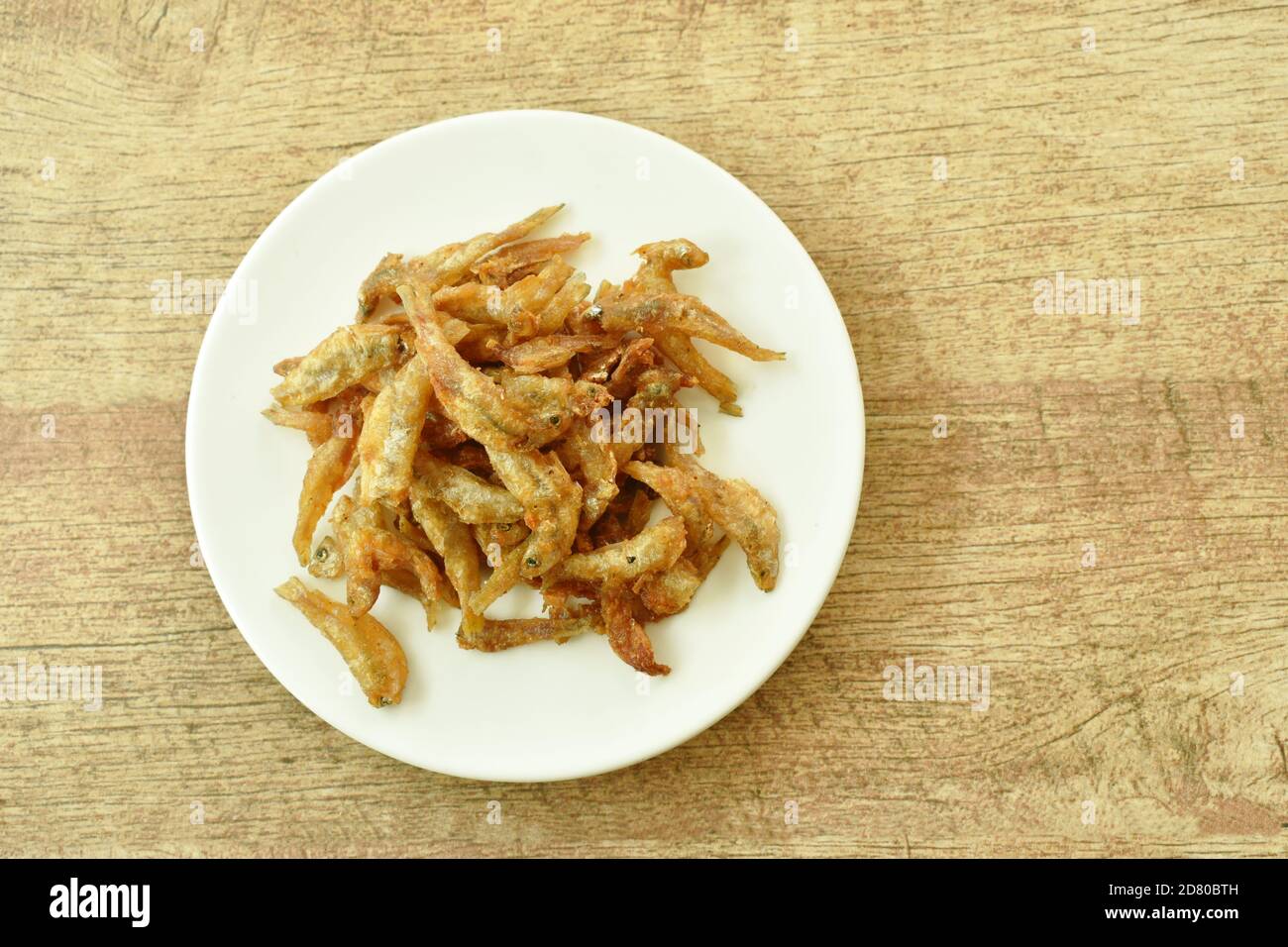 crispy fried anchovy fish with salt on plate Stock Photo - Alamy