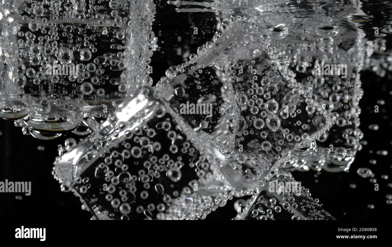 ice cube in fizzy splashing water with soda bubble Stock Photo - Alamy