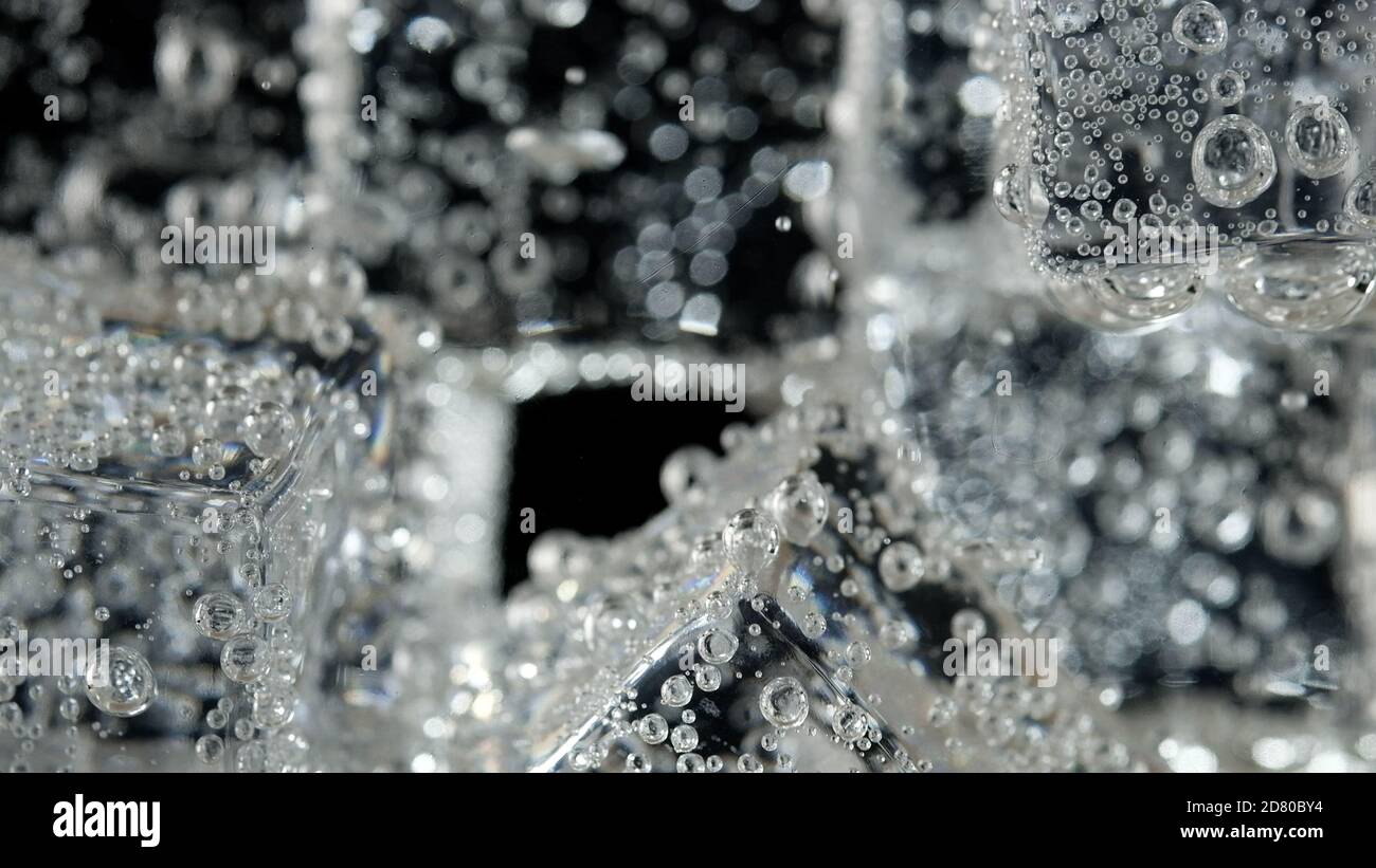 ice cube in fizzy splashing water with soda bubble Stock Photo - Alamy