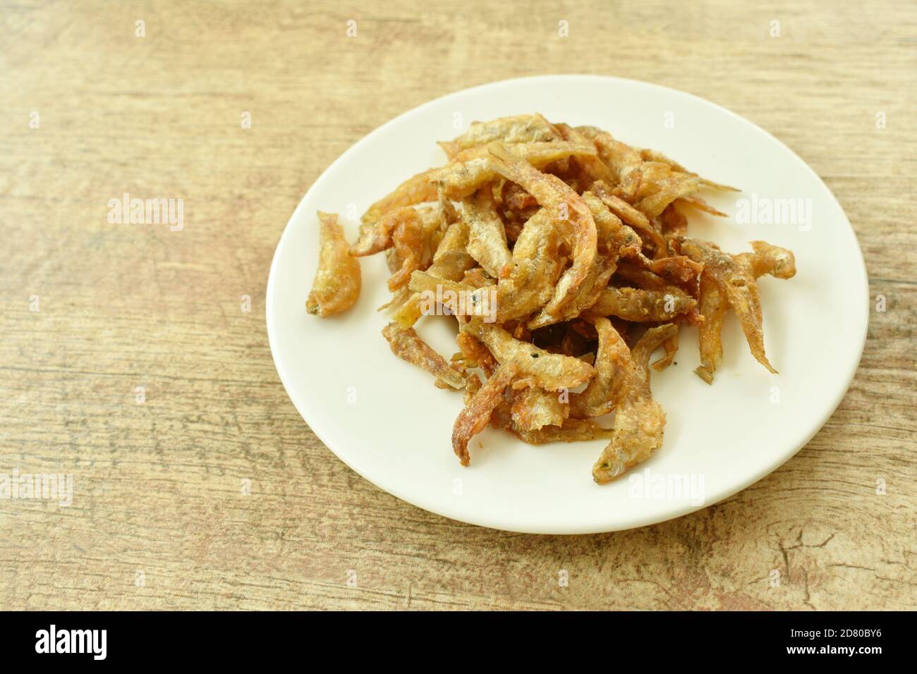 crispy fried anchovy fish with salt on plate Stock Photo - Alamy