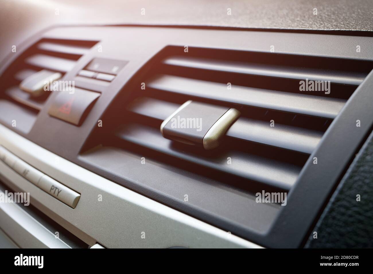 Close-up of the fan or air conditioner grilles in the car interior ...
