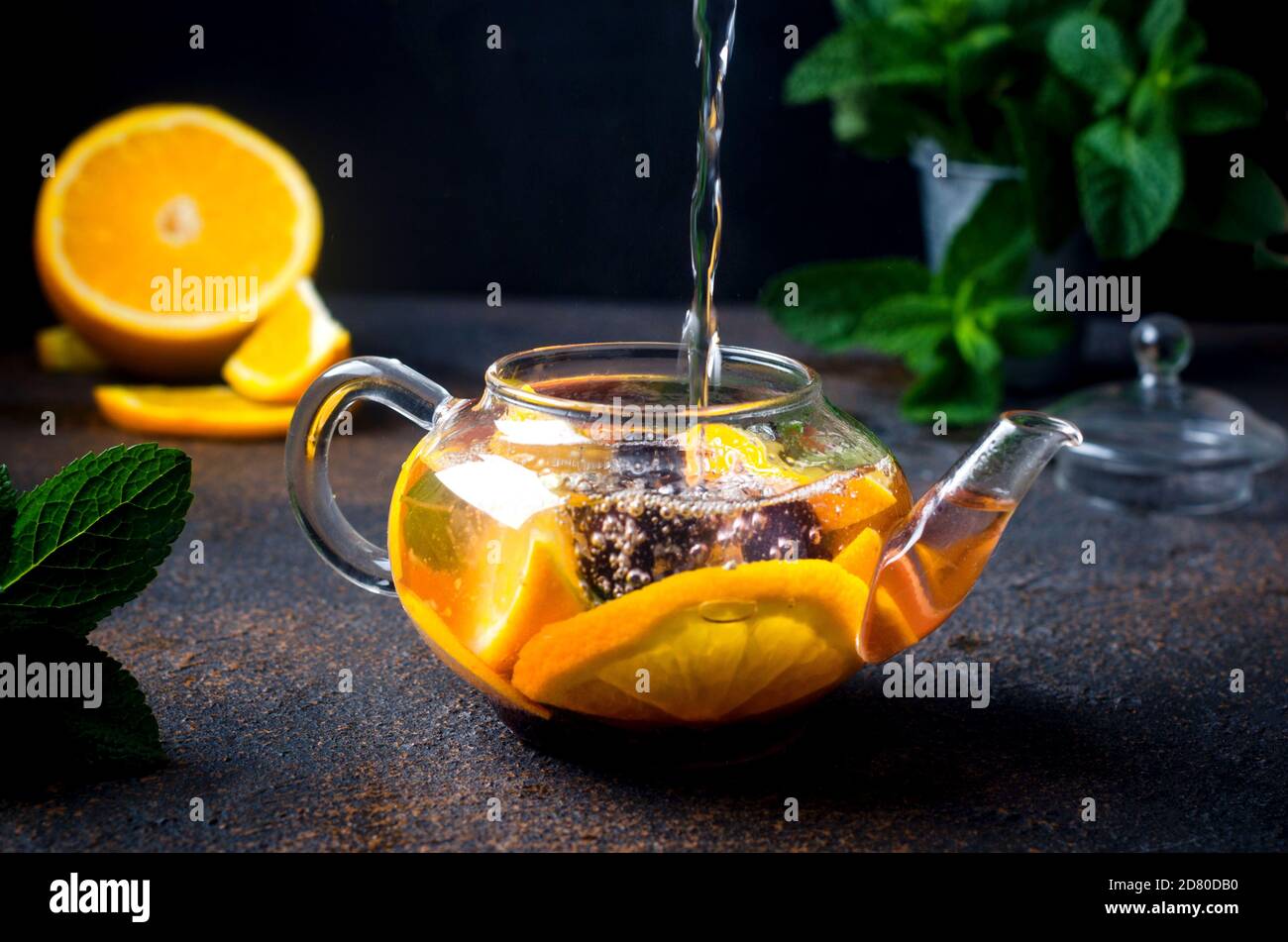 Fruit Tea with orange and lemon Slice, berry, Mint and Honey in teapot ...