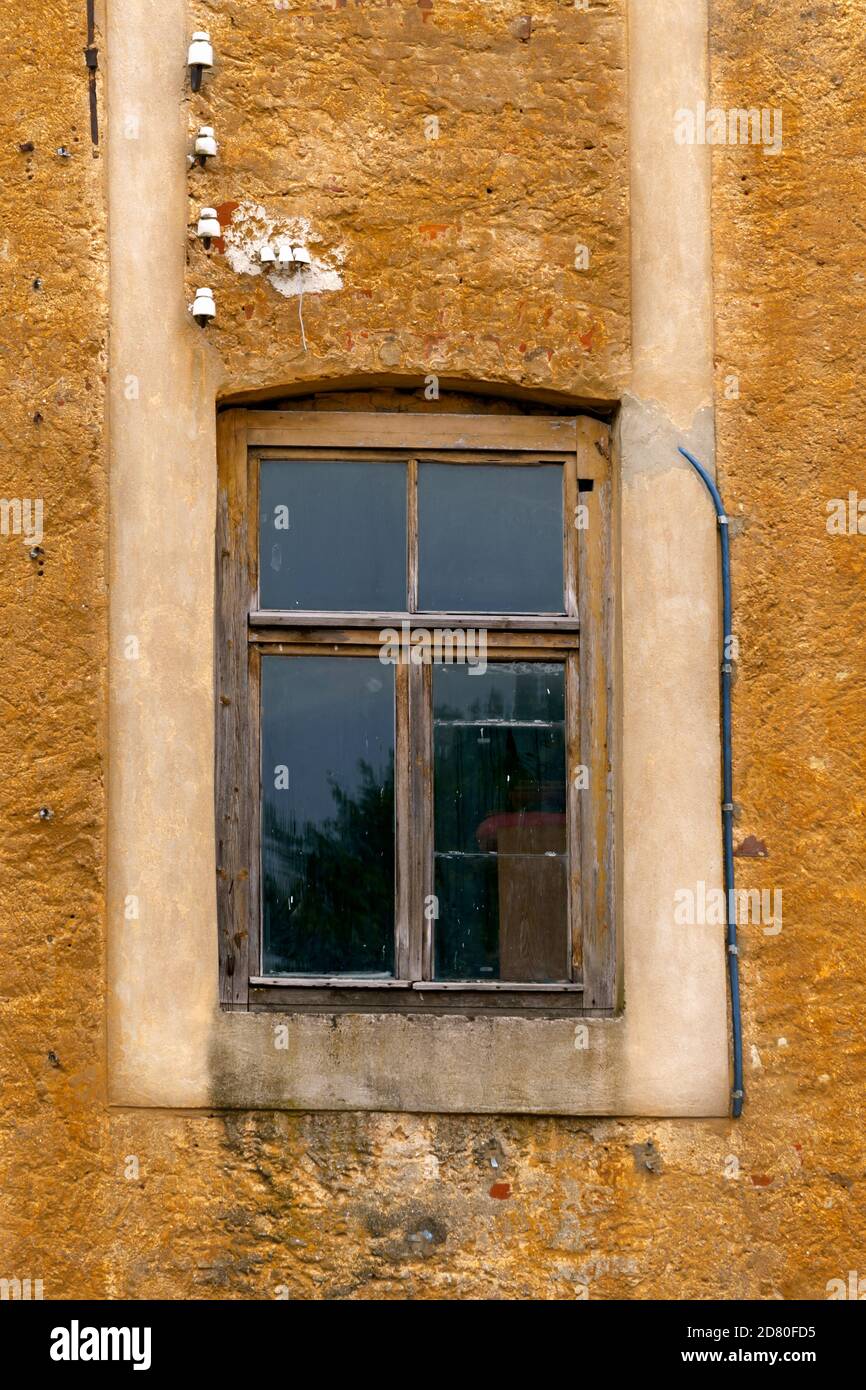An old window in a wooden frame in the opening of an old house Stock ...