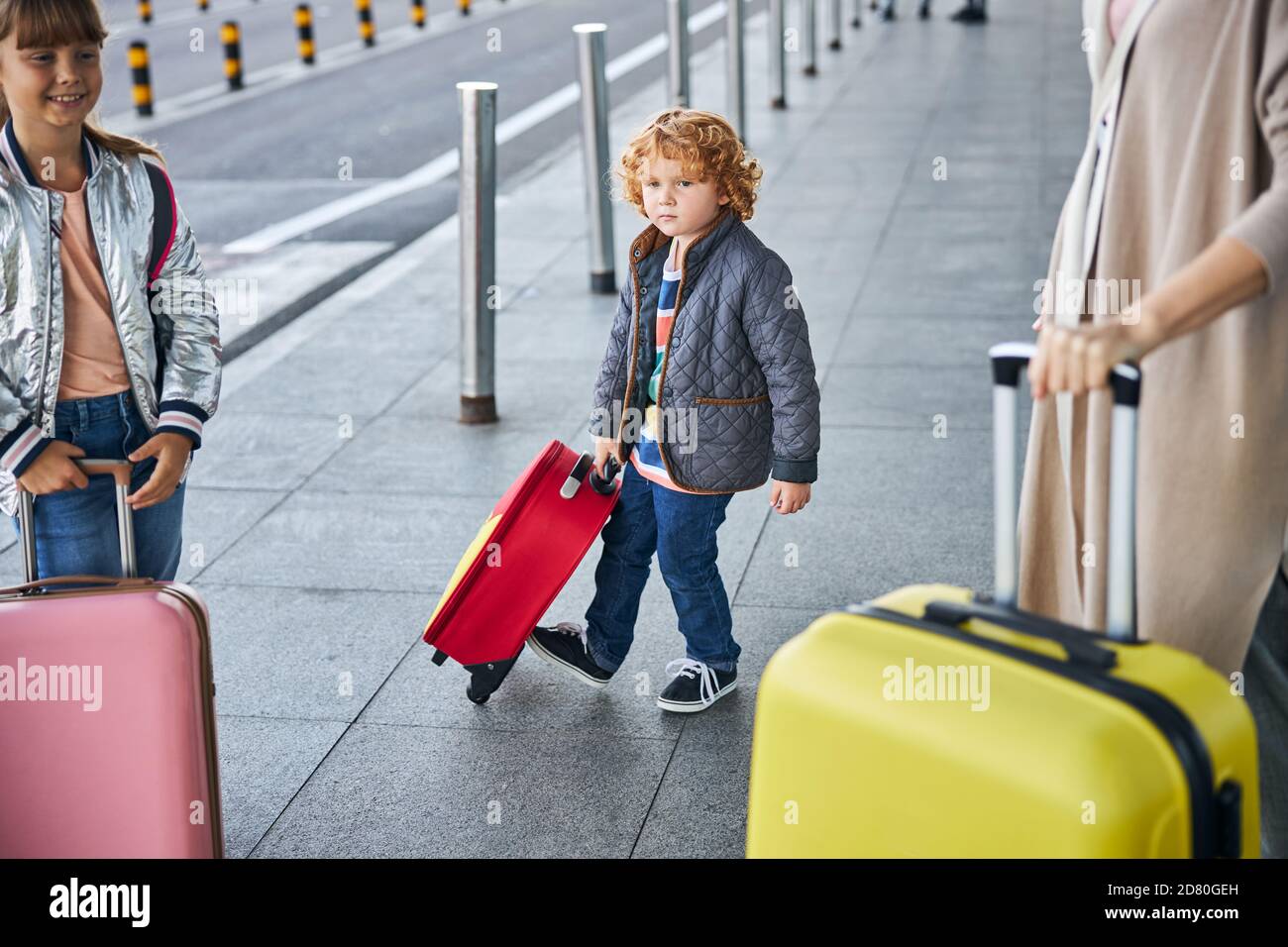 Troubled boy kicking his bag while walking Stock Photo - Alamy