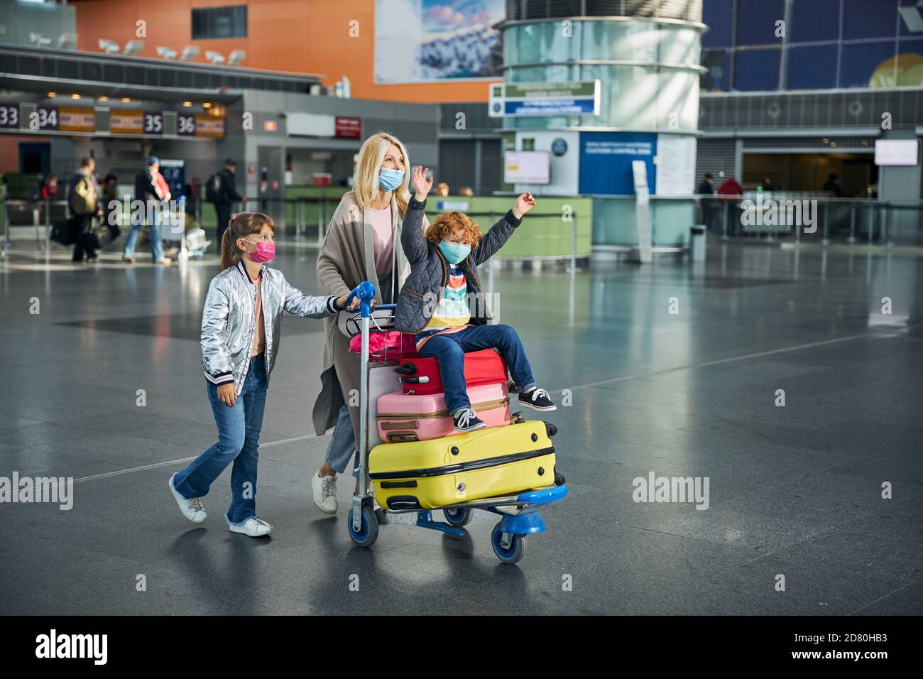 Enthusiastic boy happily raising his hands on a trolley Stock Photo - Alamy