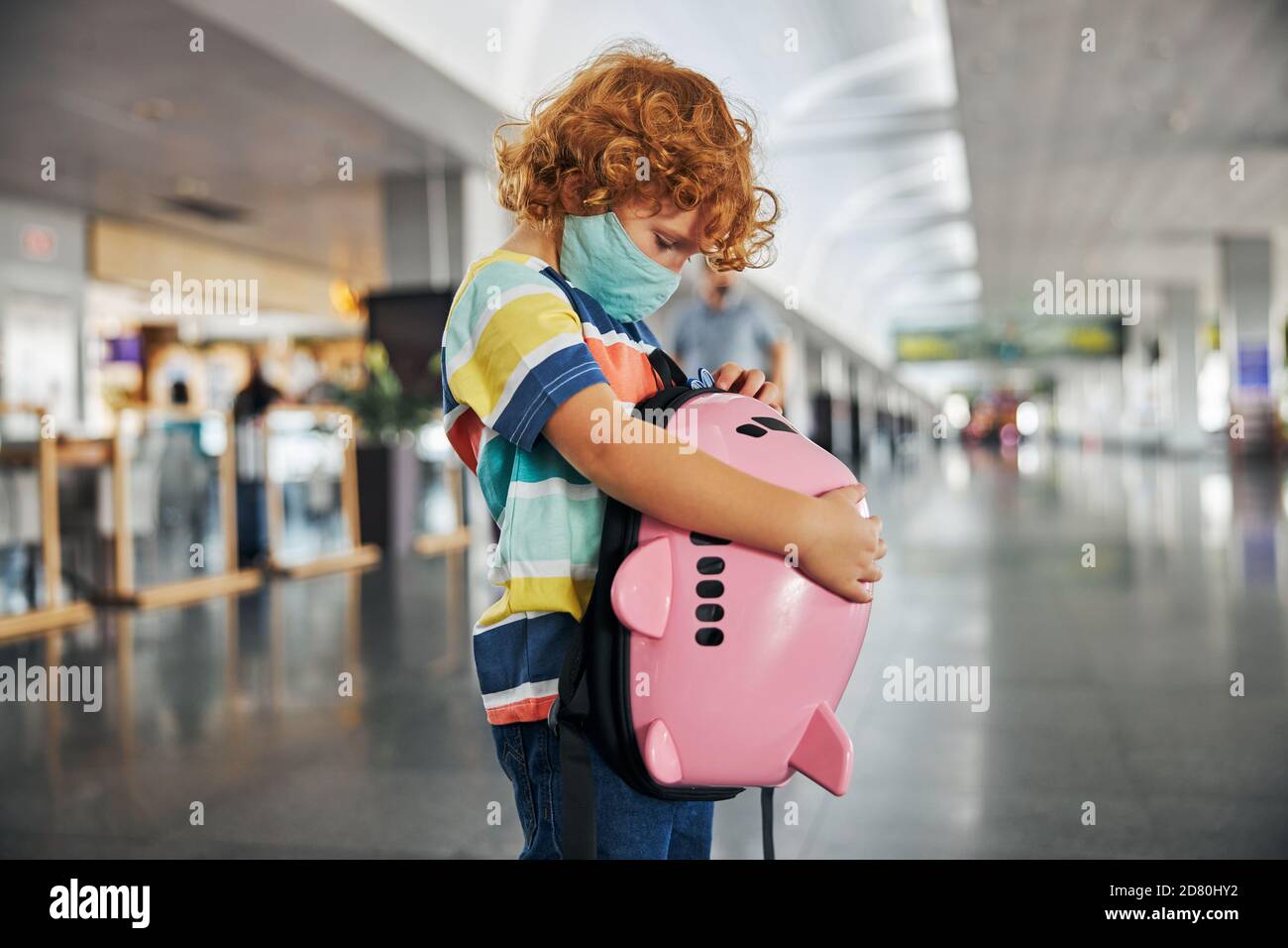 Boy searching something in his hard shell backpack Stock Photo - Alamy
