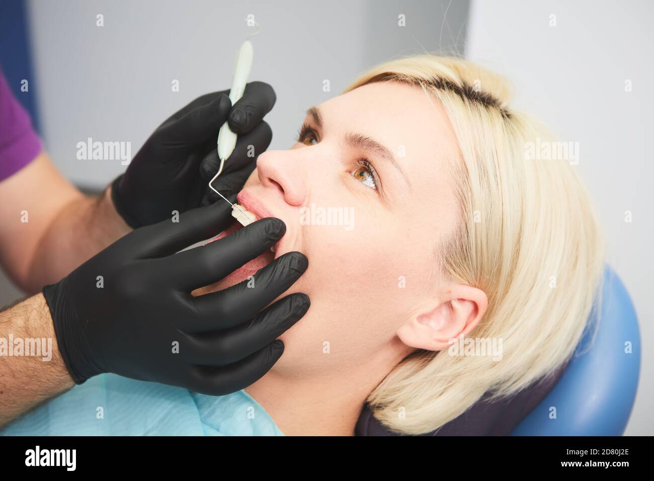 Young smiling woman with beautifiul teeth, having a dental inspection ...