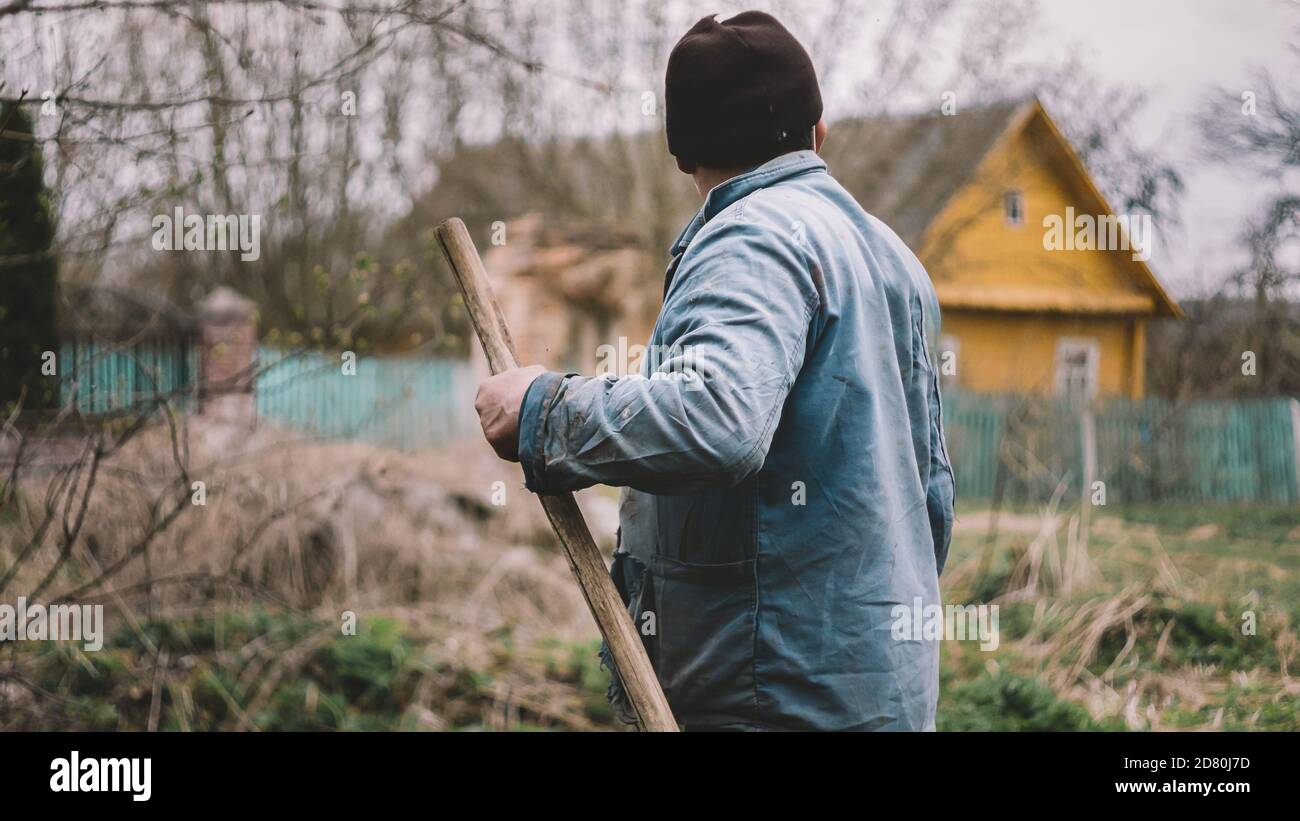 Back view of man worker with shovel on the farm rancho. Male Gardener ...