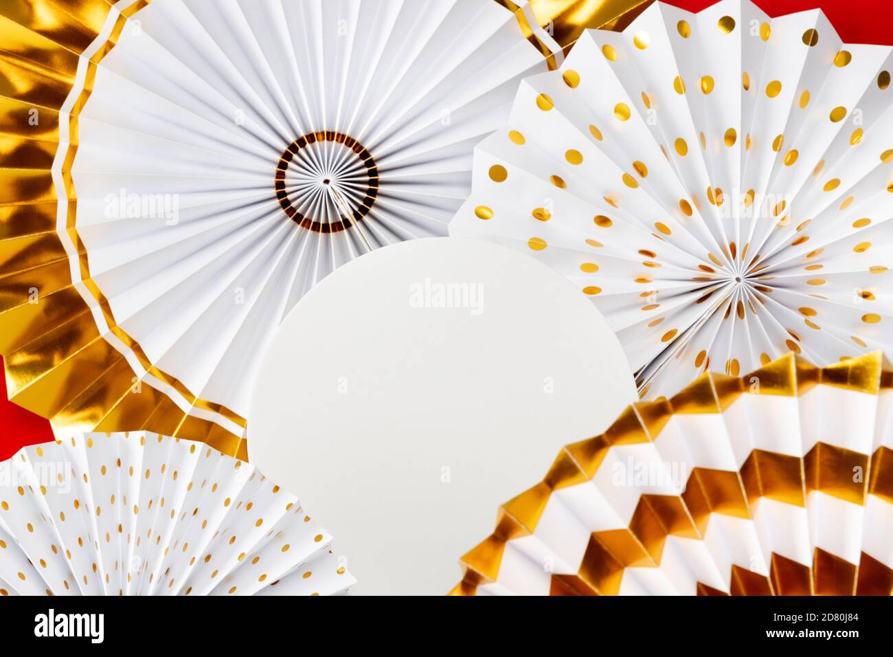 White and golden paper fans on red background. Mock up template for ...
