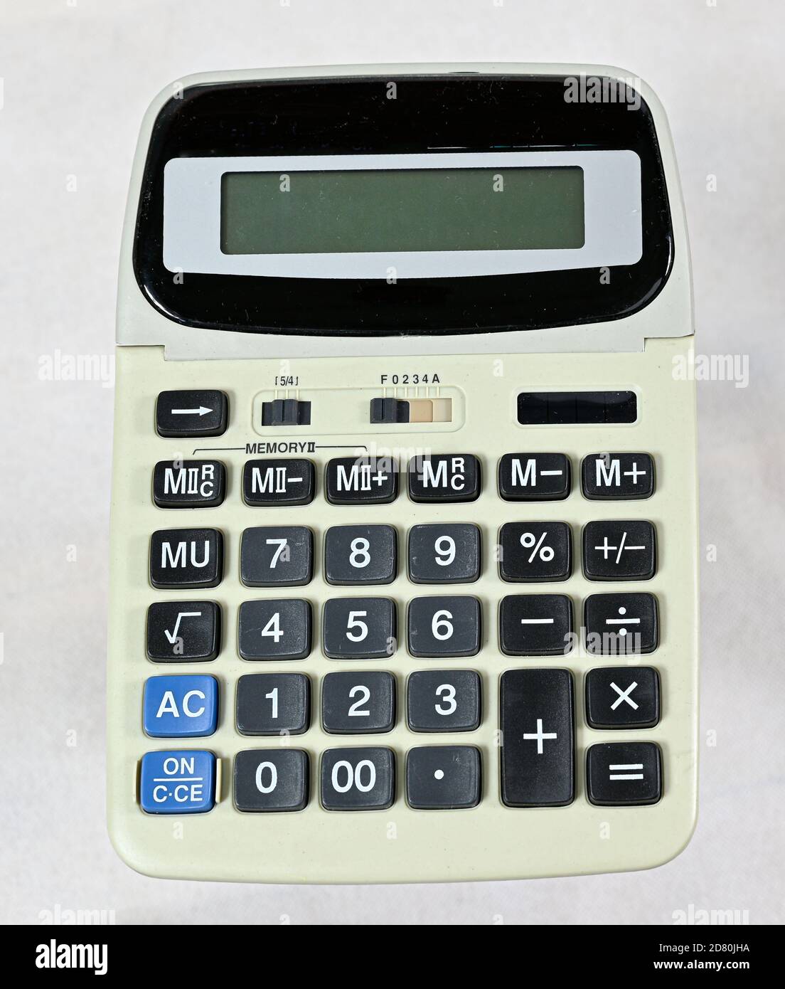 a big old calculator on white background Stock Photo - Alamy
